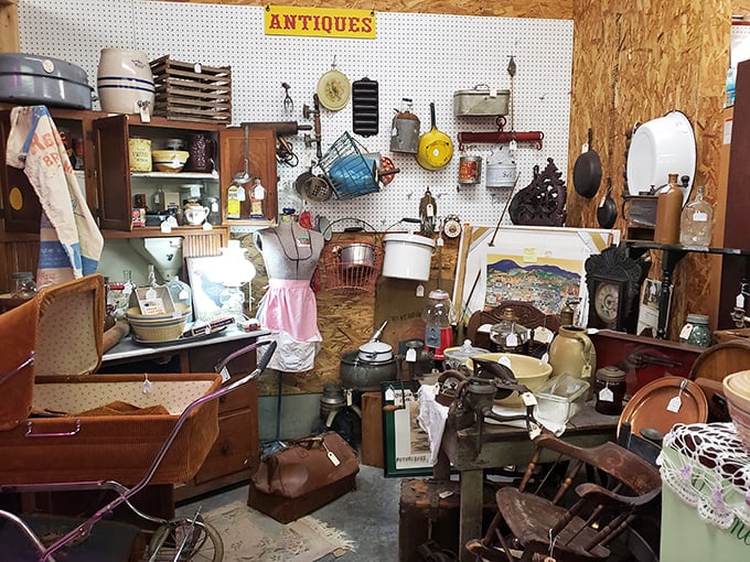 The "Antiques" sign barely hints at the organized chaos below – a domestic archaeologist's dream dig site of bygone household essentials.
