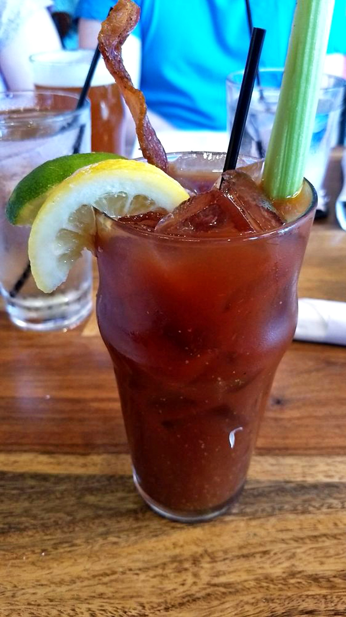 The Bloody Mary arrives like a liquid salad bar—garnished with bacon, citrus, and celery, it's practically a meal with booze benefits.