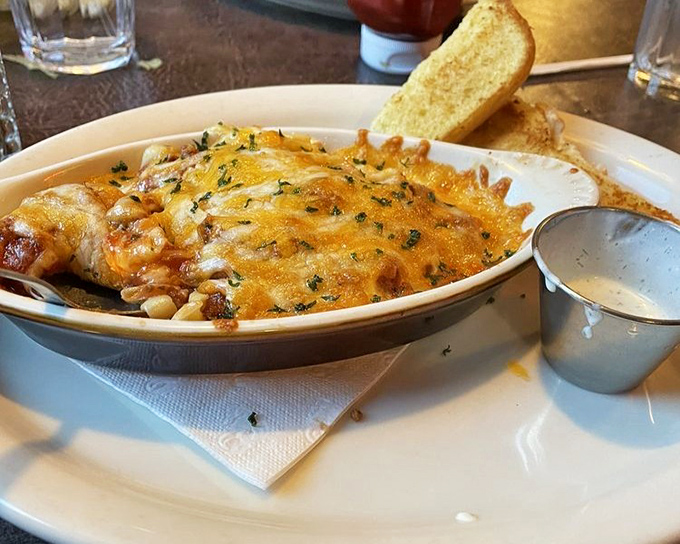 Cheese pulling double duty as both blanket and flavor enhancer on this baked spaghetti—carb heaven with a golden crown.