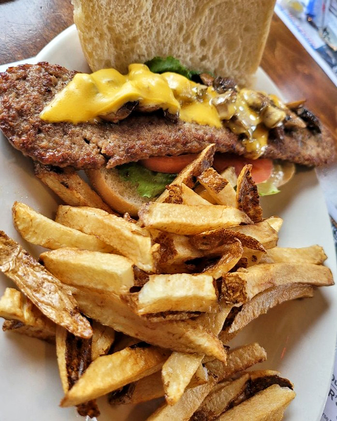 The "Bear Hunter" burger doesn't mess around—melted cheese cascading over a perfectly seared patty with hand-cut fries standing at attention.