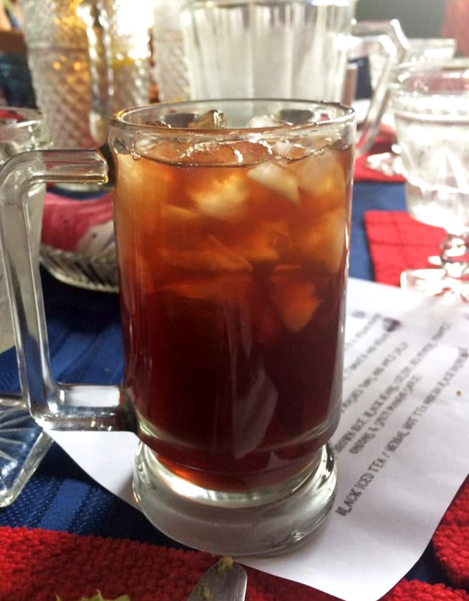 The humble mug of iced tea becomes something special here—a companion to conversation in a place where time slows down.