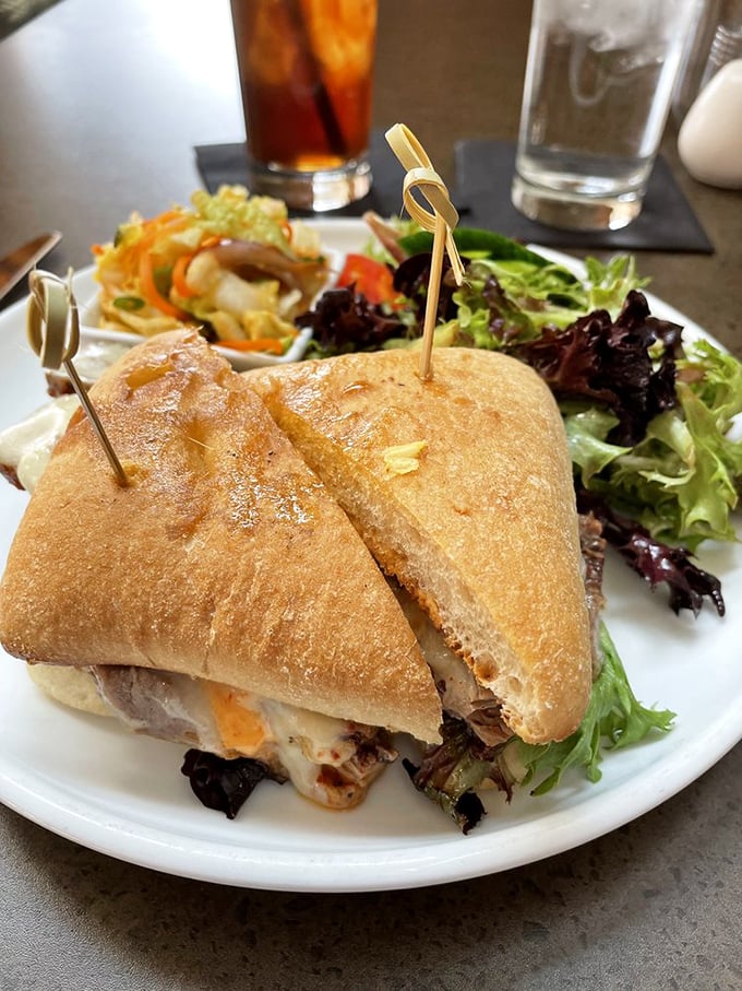 A sandwich that requires both hands and your full attention. The side salad is just pretending to be healthy – we all know why you're really here.
