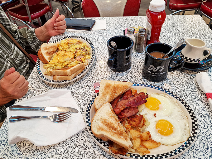 The breakfast of champions! Sunny-side-up eggs, crispy bacon, and golden hash browns—the holy trinity of morning perfection served on classic diner plates.