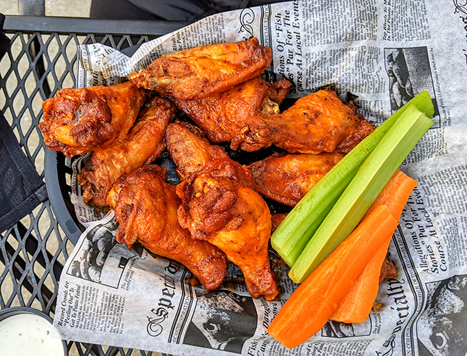 Buffalo wings served on newspaper – because sometimes the best traditions are the ones that cross borders, bringing American heat to a British setting.