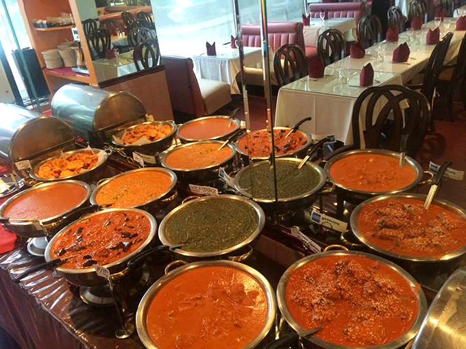 Behold the buffet in all its glory—a United Nations of curries where every pot contains diplomatic relations with your taste buds.