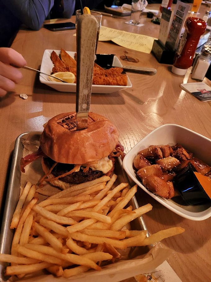 The burger arrives with a knife stabbed through its heart, as if to say, "I'm serious business." The fries and wings are just nodding in agreement.