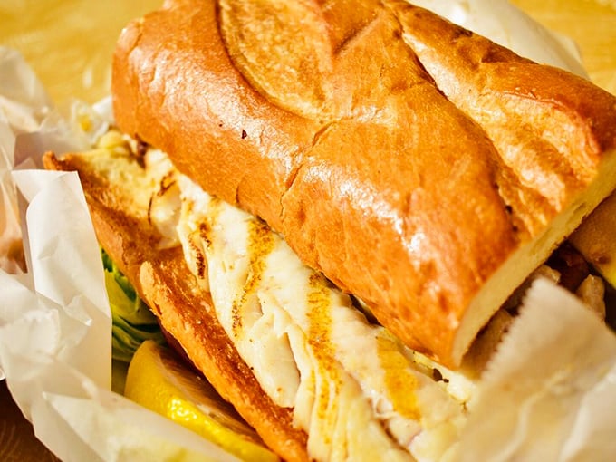 This isn't just a fish sandwich—it's architectural genius with layers of perfectly seasoned fish, crisp vegetables, and pillowy bread.
