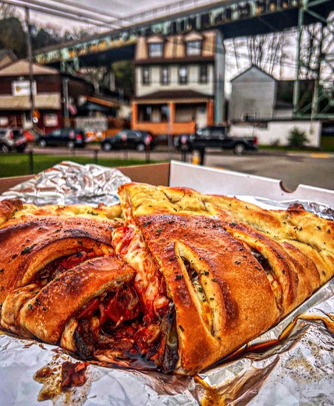 This isn't just a calzone—it's a magnificent carb fortress protecting precious cheese and toppings. The kind of meal that demands a post-consumption nap.