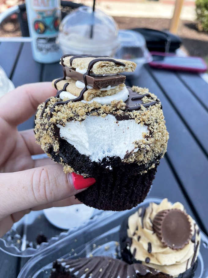 This isn't just a cupcake—it's architecture with frosting, crowned with a s'mores-inspired hat that belongs in a dessert hall of fame.