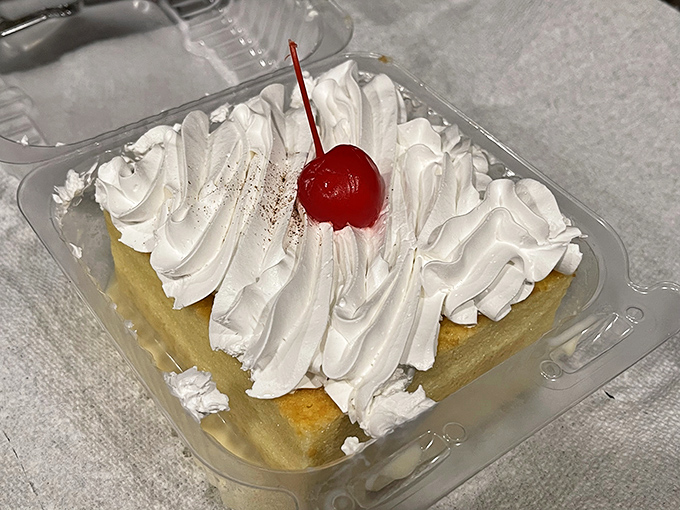 Tres leches cake topped with a cloud of whipped cream and a cherry on top – the dessert equivalent of finding an unexpected twenty in your winter coat pocket.