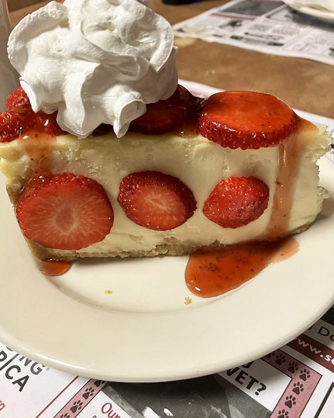Strawberry cheesecake that doesn't just satisfy sweet cravings—it resolves them with diplomatic elegance, the whipped cream ambassador sealing the deal..