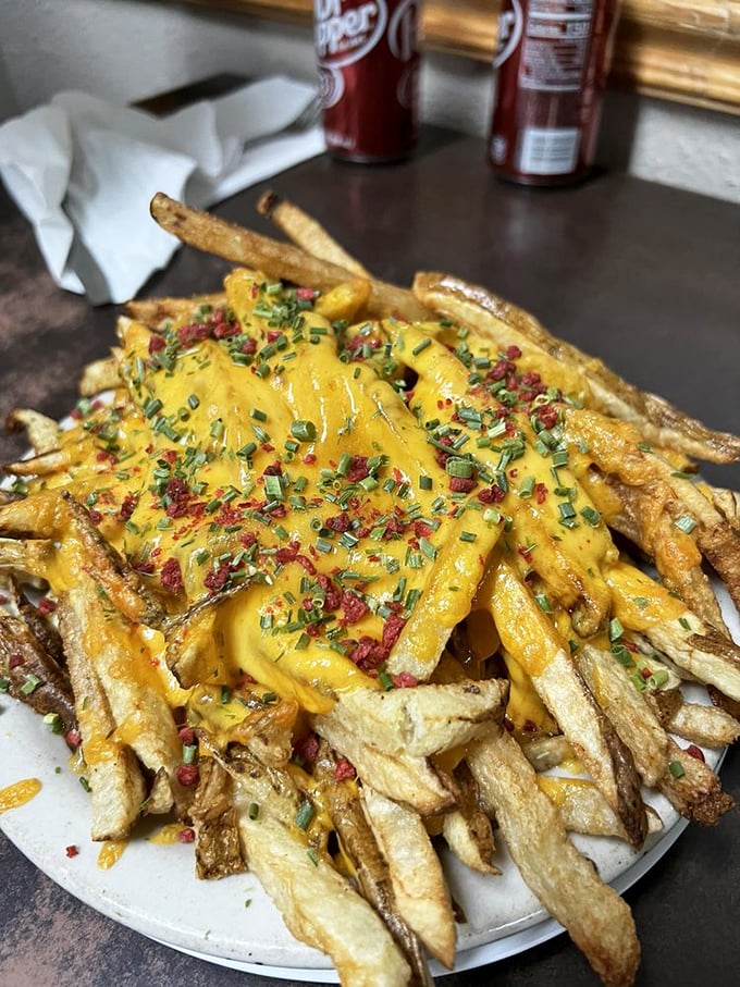 Loaded fries that blur the line between side dish and main event, draped in molten cheese and sprinkled with enough fixings to make you forget your table manners.