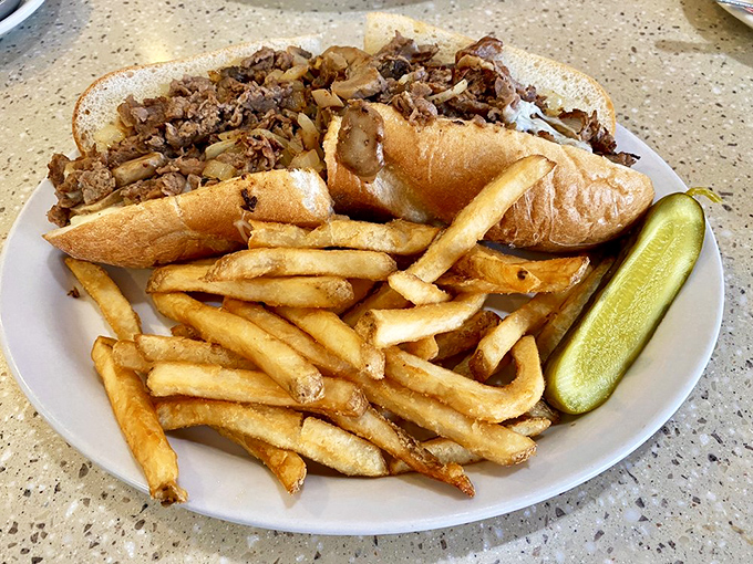 The Philly cheesesteak: a sandwich so important they named the city after it. Those fries aren't just sidekicks—they're co-stars.