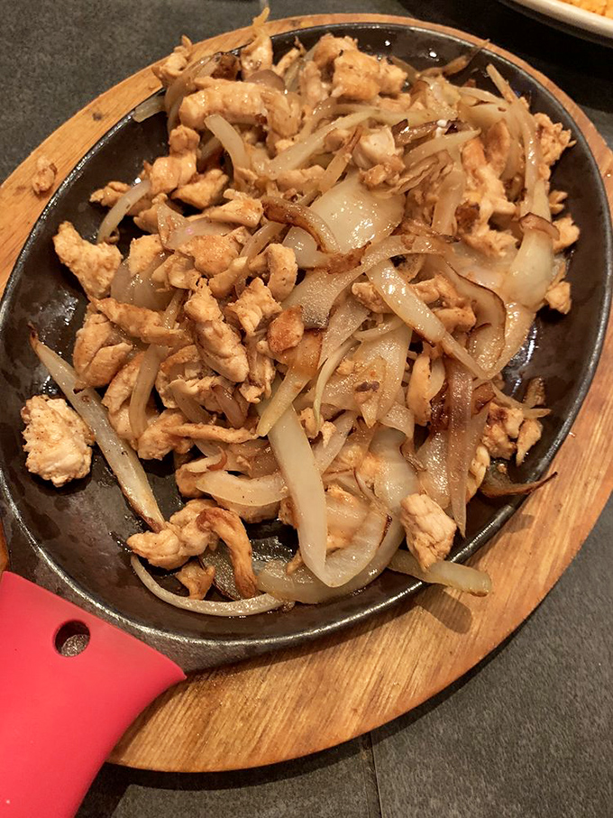 Sizzling chicken fajitas that announce their arrival with both sound and aroma—like a rock star making an entrance that demands your full attention.