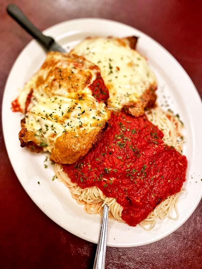 Chicken Parmigiana that doesn't mess around—golden, crispy cutlets buried under cheese and marinara that would make any Italian grandmother nod in approval.
