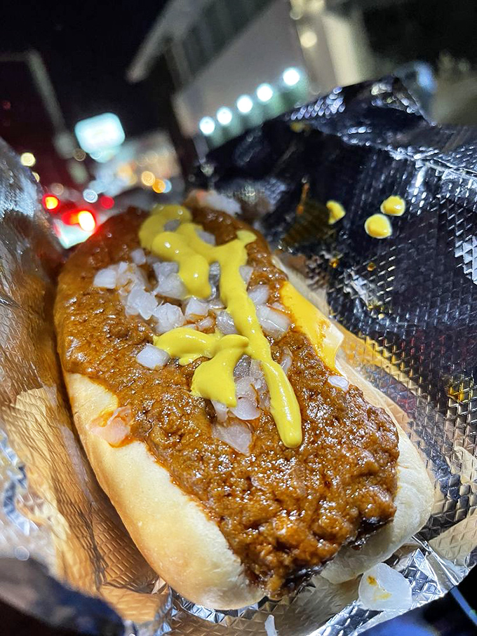 The classic chili cheese dog that started countless pilgrimages and probably a few family feuds over recipes.