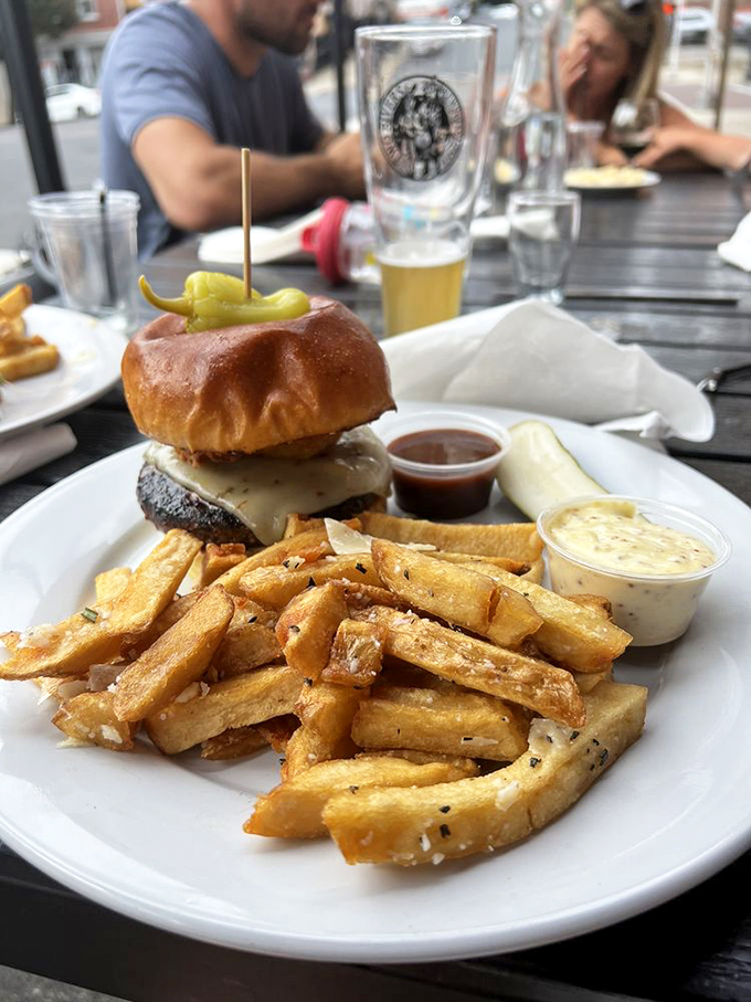 Two burgers, two salads, one golden beer—a table setting that says "I'm treating myself today" without speaking a word.