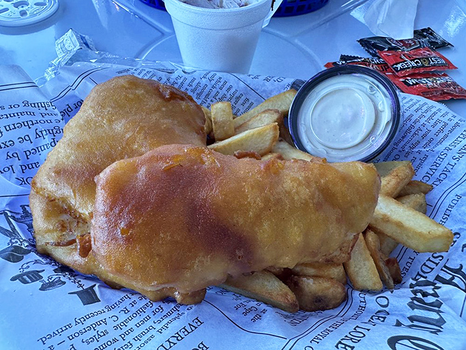The newspaper wrapping isn't just nostalgic – it's practical. Though at The Chipper, this fish is so good you'll want to frame it, not read it.