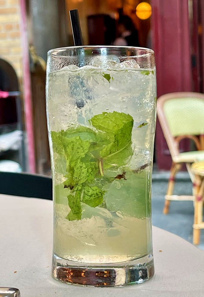 A proper mojito with fresh mint leaves standing at attention—the kind of drink that makes you forget you're in Philadelphia, not Paris.