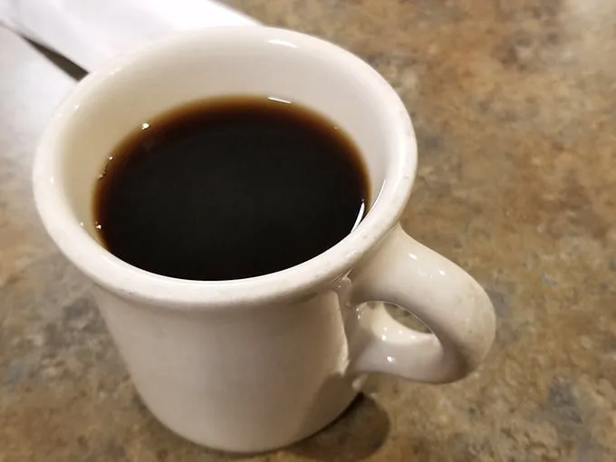 The coffee comes in those iconic thick white mugs that somehow make everything taste better. This isn't artisanal pour-over—it's the reliable fuel of America.