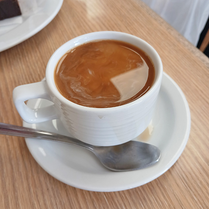 Coffee served European-style—strong enough to wake the dead but smooth enough to make them happy about it.
