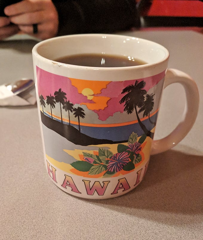 Even the coffee mugs tell stories here—this Hawaiian souvenir cup holding strong, no-nonsense diner coffee is the perfect metaphor for this delightfully mismatched cafe.