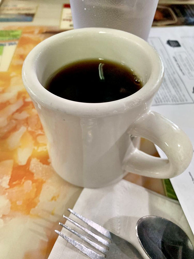 The humble diner coffee mug – holding the life-giving elixir that transforms morning zombies into functioning humans since time immemorial.