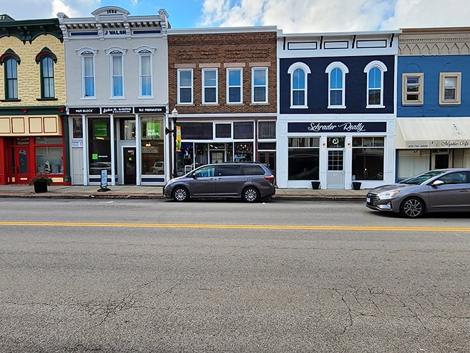 A painter's palette of storefronts showcasing the architectural equivalent of a well-coordinated outfit—different styles that somehow work perfectly together.