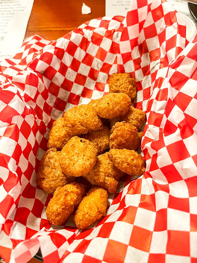 Golden-fried corn nuggets nestled in their checkered paper cradle – little bombs of sweetness with a crispy exterior that defies resistance.