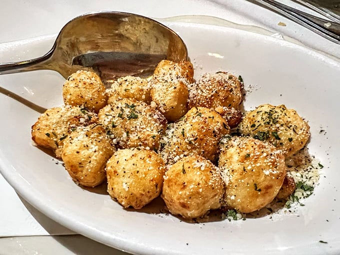 These aren't your nonna's gnocchi—they're deep-fried pillows of potato heaven dusted with parmesan fairy dust that disappears too quickly.
