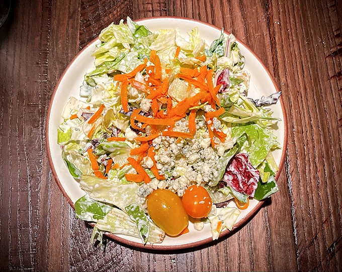 A dinner salad that doesn't apologize for being simple—crisp lettuce, fresh vegetables, and just enough dressing to keep things interesting.