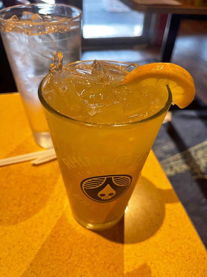 A refreshing adult beverage with a lemon slice – because sometimes hot dog adventures require proper hydration with a hint of sophistication.