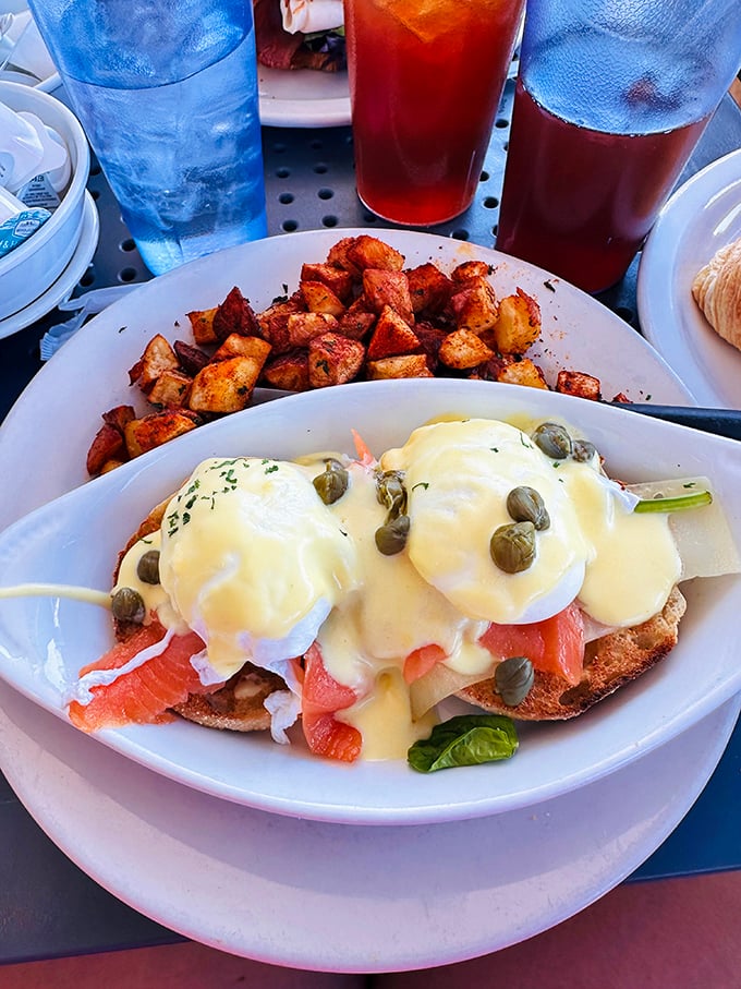 Eggs Benedict elevated to an art form—poached eggs perched atop smoked salmon with hollandaise cascading like a buttery waterfall.