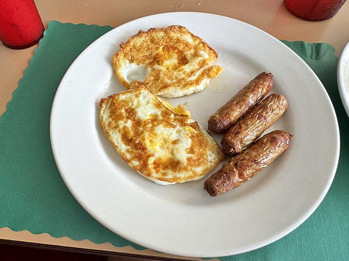 Simplicity perfected: eggs with that ideal balance between runny and set, alongside sausage links with the perfect snap.