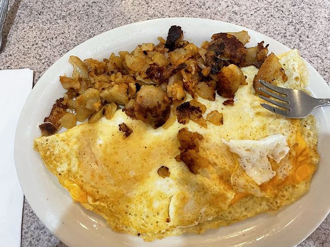 The perfect omelet doesn't hide its ingredients—it celebrates them. Those home fries on the side? They're the unsung heroes of breakfast plates everywhere.