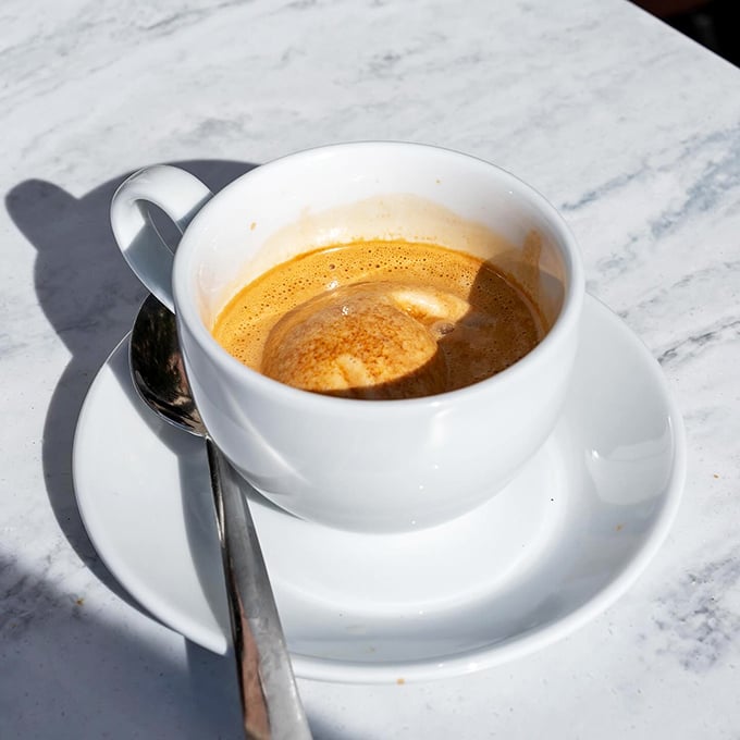 An espresso at Carmella's isn't just coffee—it's liquid motivation served in a porcelain vessel of possibility.