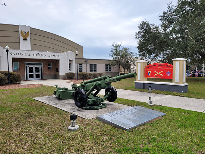 The National Guard Armory stands ready with its vintage artillery display – a reminder of history that thankfully doesn't involve Florida Man headlines.