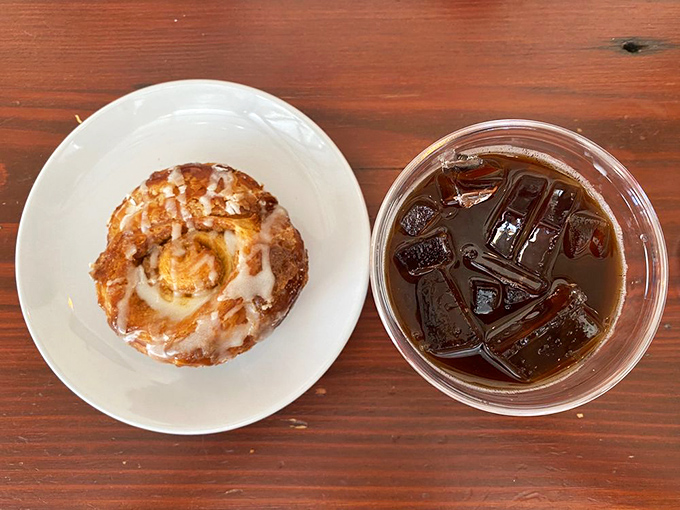A cinnamon roll and iced coffee: the breakfast of champions who understand that life's too short to skip dessert, even at 8 AM.