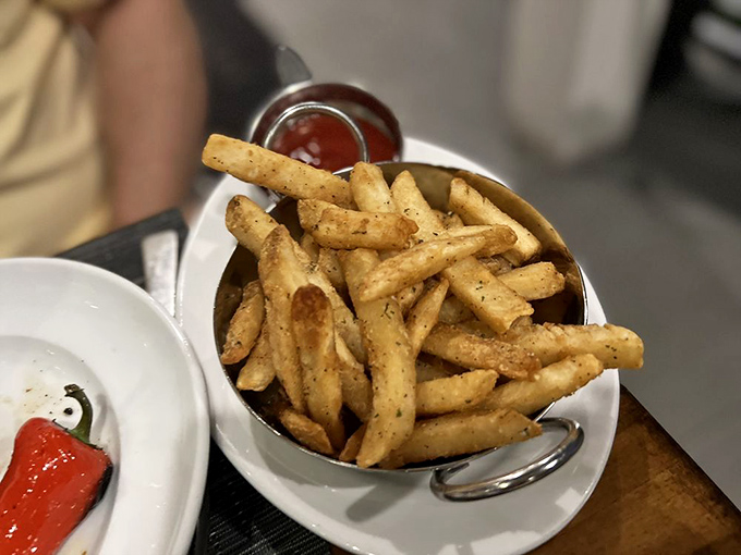 French fries elevated to art form—golden, crispy, and served in a miniature pot that somehow makes them taste even better.