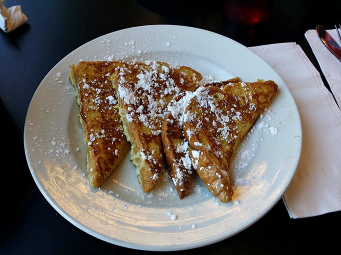 French toast that makes you question why anyone bothers with fancy brunch. Perfectly golden, dusted with powdered sugar, and absolutely no pretension.