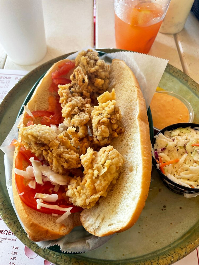 This fried oyster po'boy isn't just a sandwich – it's a textural masterpiece where crispy, briny treasures meet soft bread in perfect harmony.