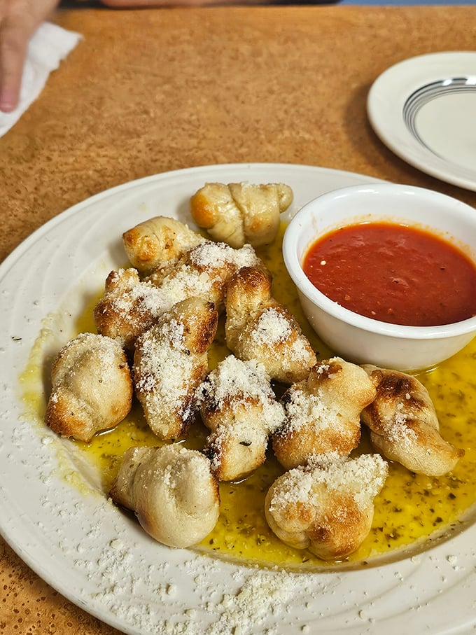 Garlic knots basking in buttery, garlicky glory. These little pillows of joy are what garlic bread dreams of becoming when it grows up.