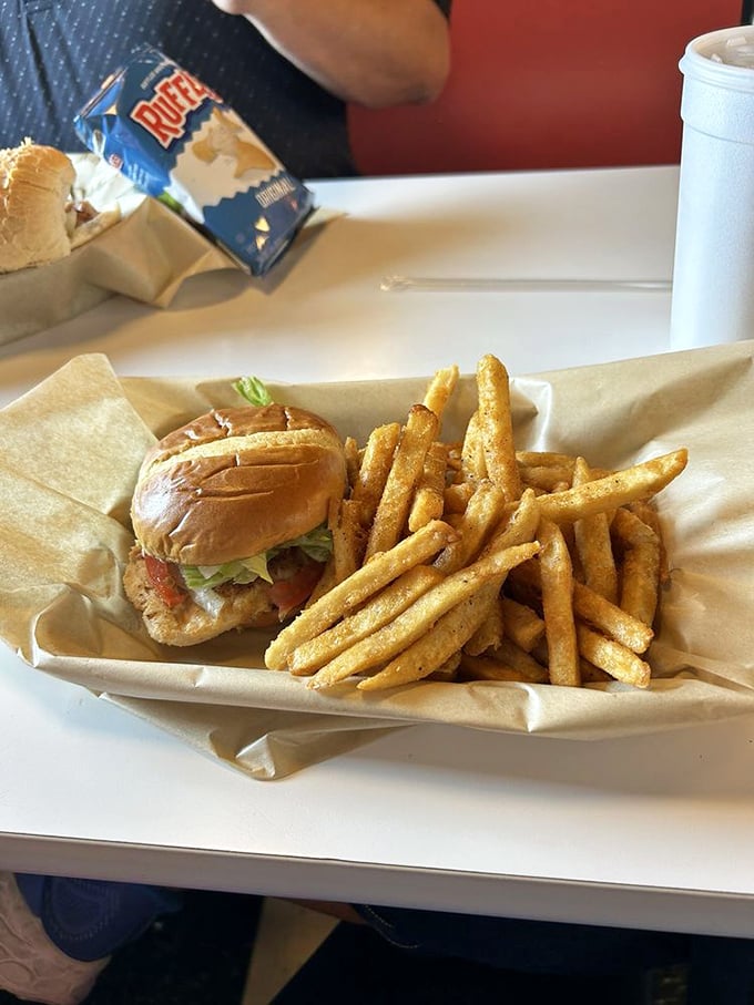 Sometimes the simplest pleasures win – fresh lettuce, tomato and grilled chicken on a roll that knows its supporting role perfectly.