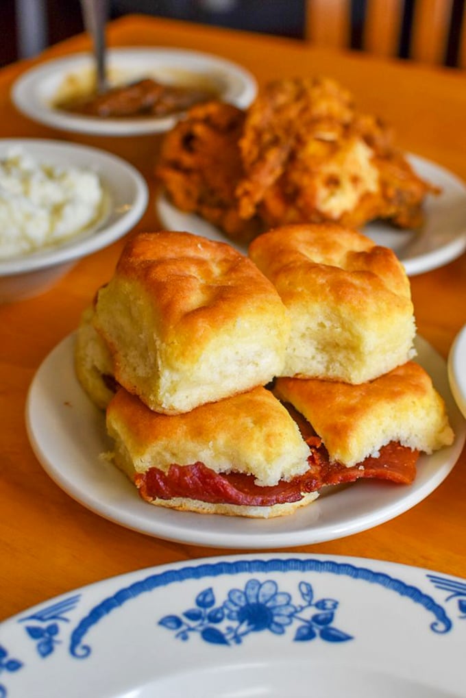 Pillowy biscuits cradling salty country ham—a perfect marriage that's lasted longer than most Hollywood couples and twice as satisfying.
