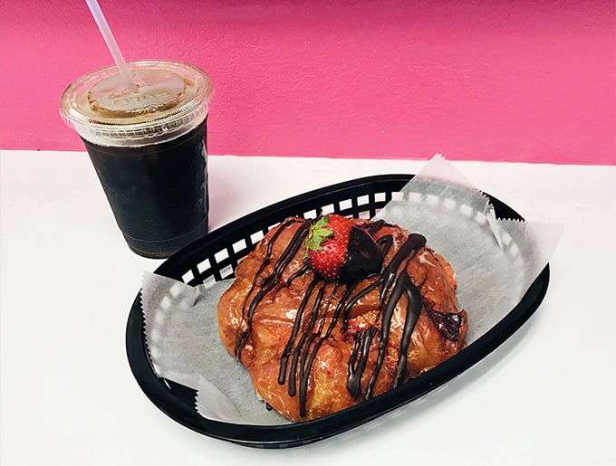 The chocolate-drizzled strawberry croissant paired with iced coffee – because sometimes breakfast should feel like dessert with permission.