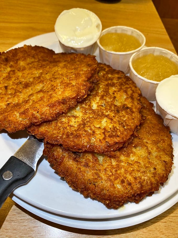 Golden-brown latkes with their crispy edges and tender centers await the perfect topping – applesauce or sour cream? Why not both?