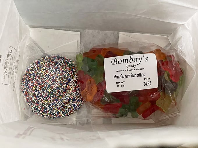 Chocolate nonpareils and gummy butterflies sharing a box like unlikely roommates in a sitcom. One crunchy, one chewy—both irresistible.