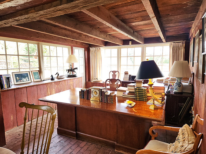 This isn't just an office—it's a command center for literary treasures, where sunlight pours in and every surface tells stories of books that have passed through.