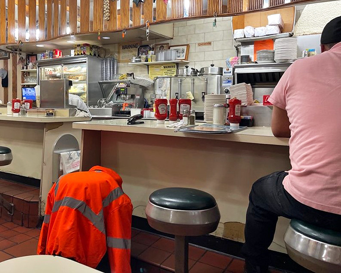 The counter—where solo diners become temporary family, watching short-order cooks perform their sizzling ballet just feet away.