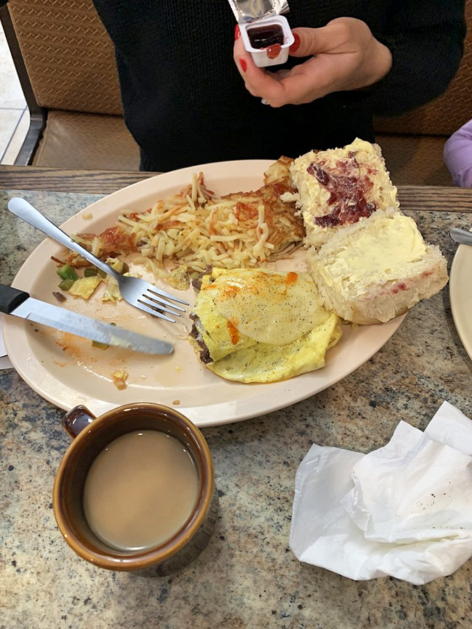 Half-eaten plates tell the real story - this breakfast was so good, someone couldn't wait for the photo op. Coffee in a sturdy mug completes this morning masterpiece.